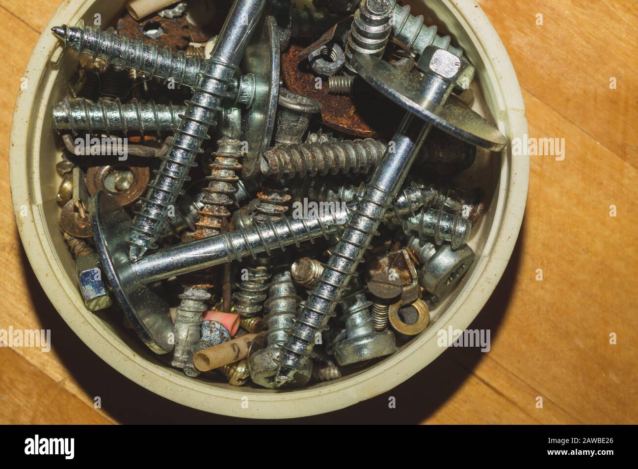 Old screws in a box. a lot of various screws. pile of fasteners in the ...