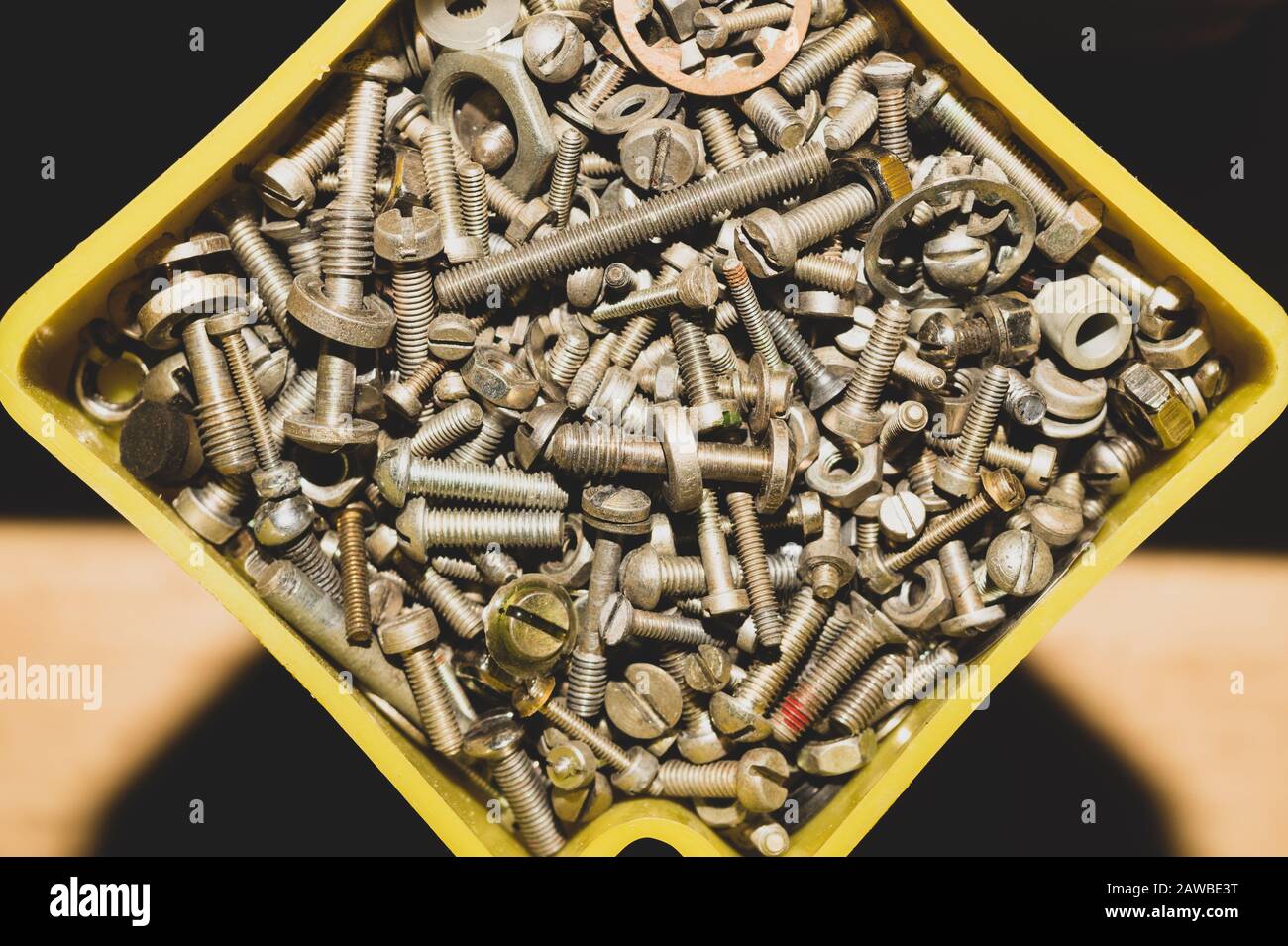 Old screws in a box. a lot of various screws. pile of fasteners in the ...