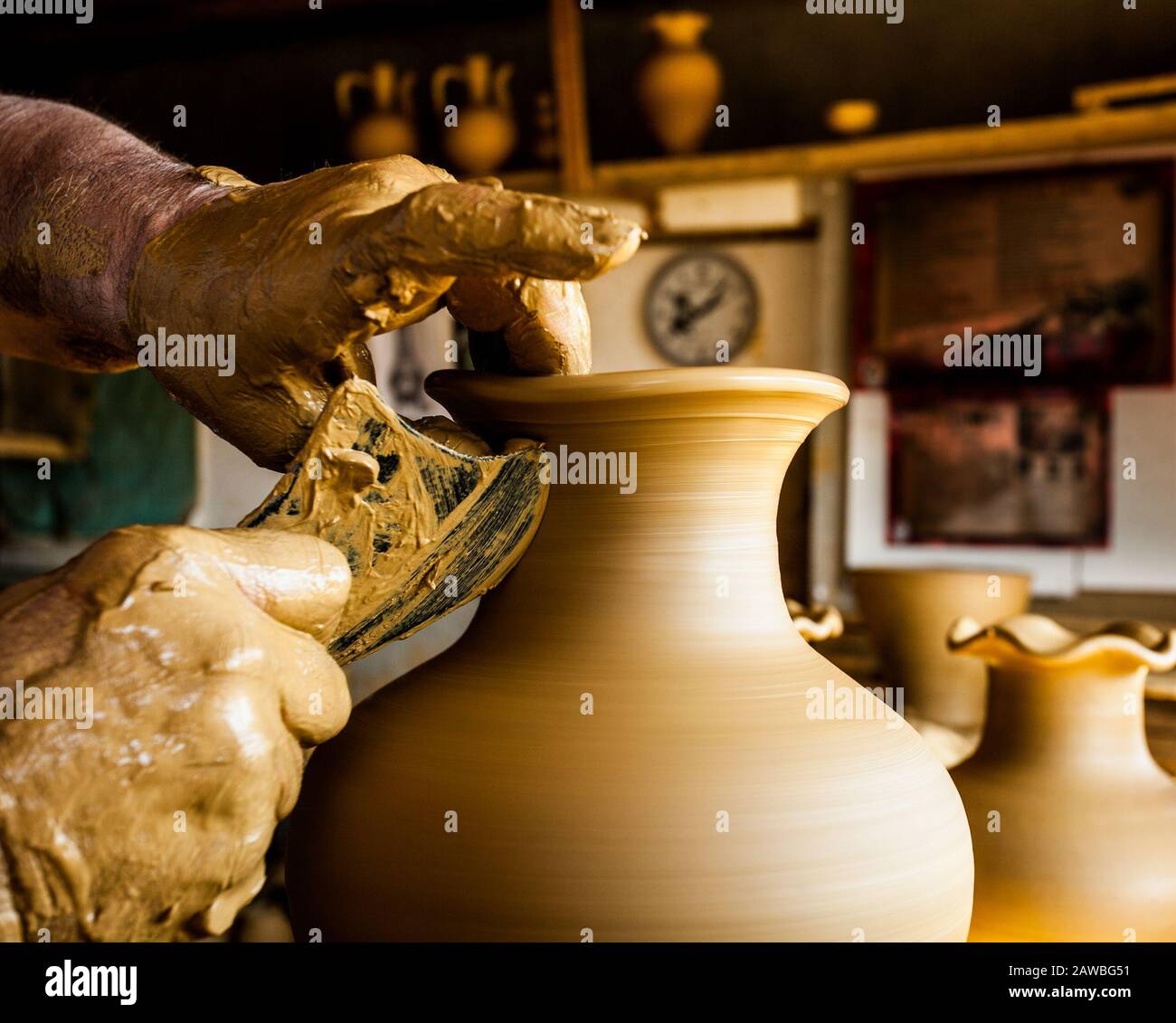 Making Pottery from clay. Man Hands working on pottery wheel and making ...
