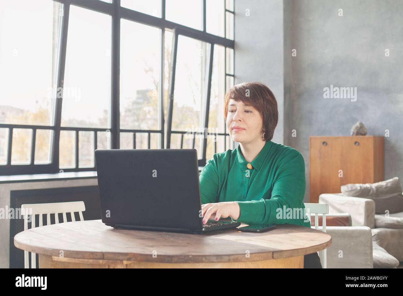 Smart mature woman working laptop computer indoors Stock Photo - Alamy