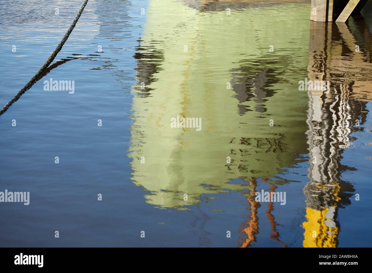Green reflection from a ship, Blue Water surface Stock Photo - Alamy