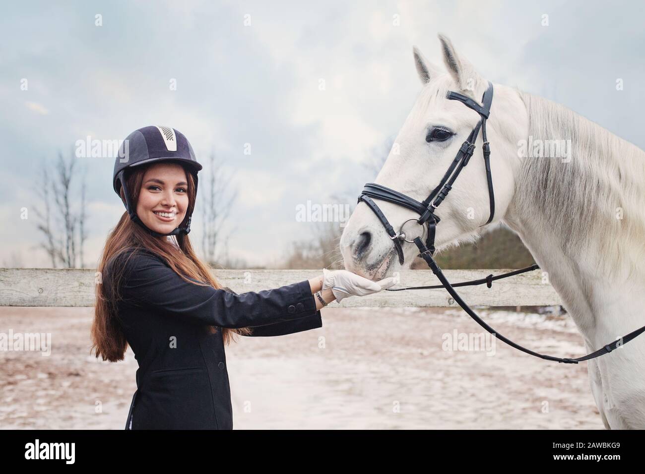 Pretty woman with white horse, outdoors portrait Stock Photo - Alamy