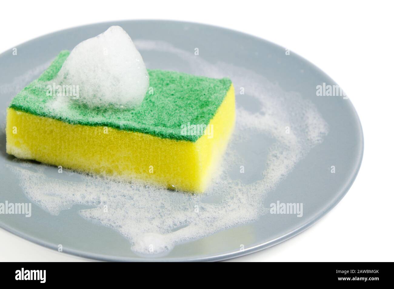 Foam sponge for washing dishes, dirty gray plate on a white background ...