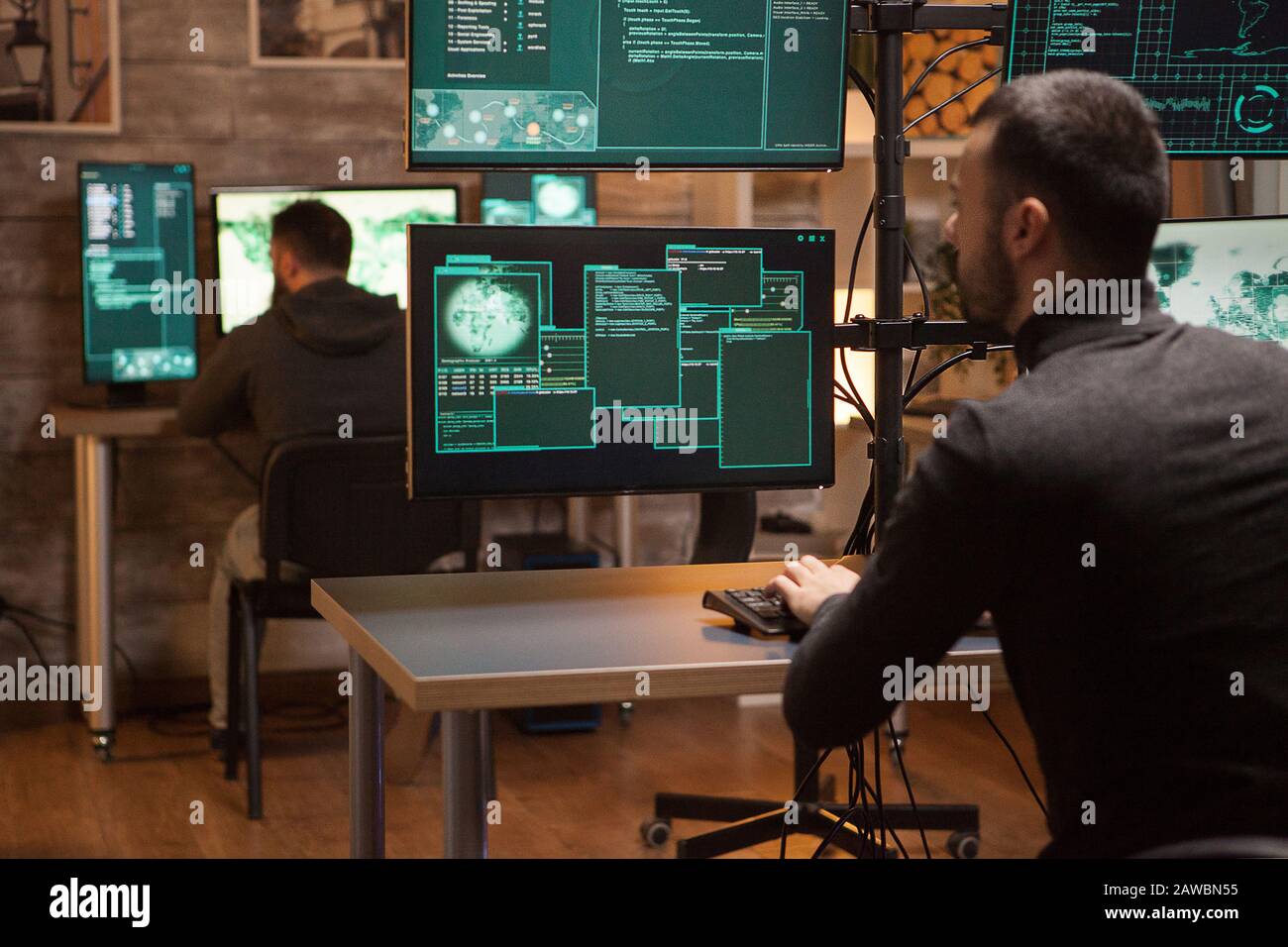 Back view of dangerous team of hackers working on a new malware Stock ...