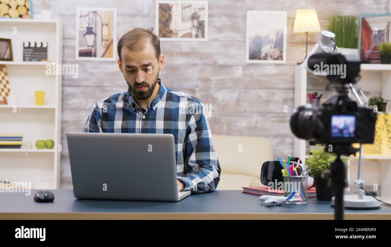 Creative content creator recording review of laptop. Famous vlogger ...