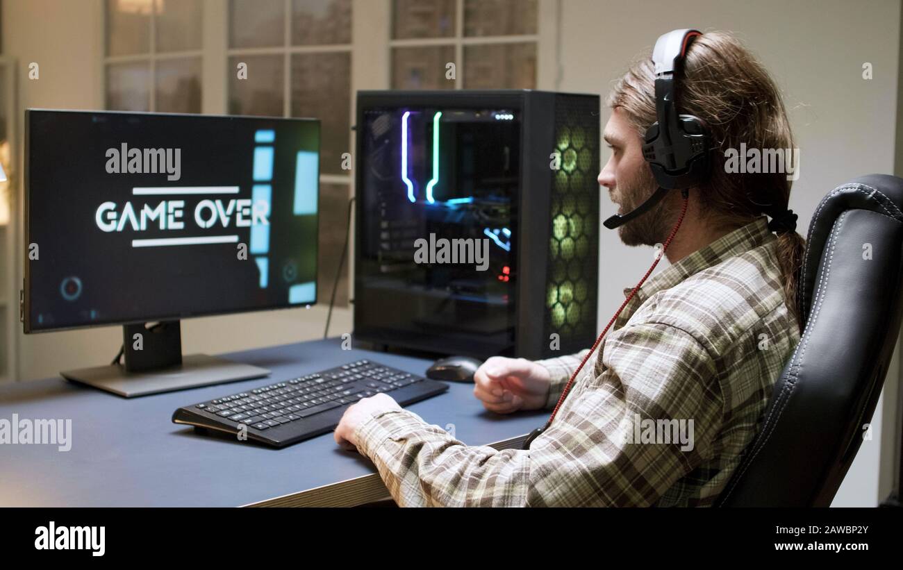 Male gamer with long hair can't believe he lost while playing shooter ...