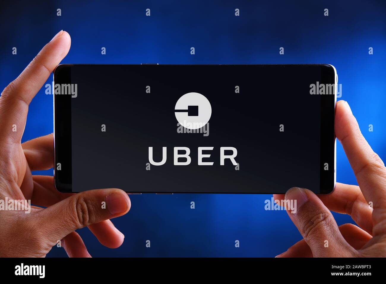 POZNAN, POL - JUL 10, 2019: Hands holding smartphone displaying logo of ...