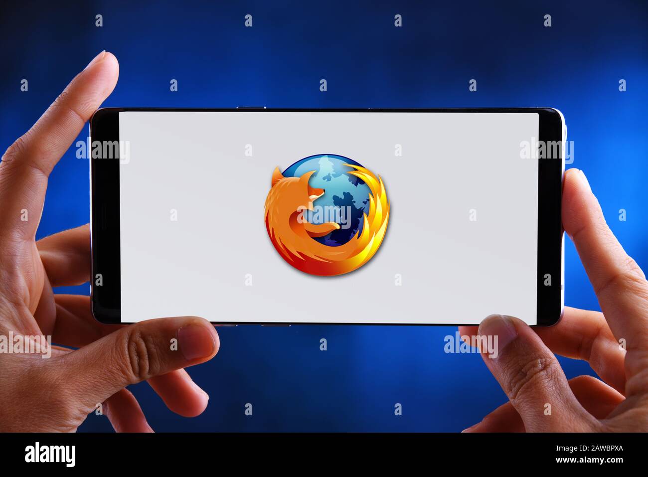 POZNAN, POL - JUL 10, 2019: Hands holding smartphone displaying logo of ...