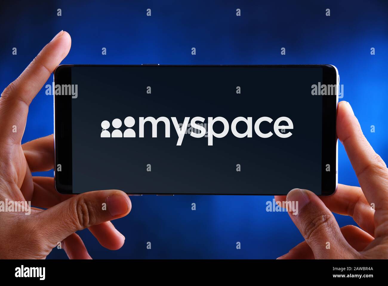 POZNAN, POL - JUL 10, 2019: Hands holding smartphone displaying logo of ...