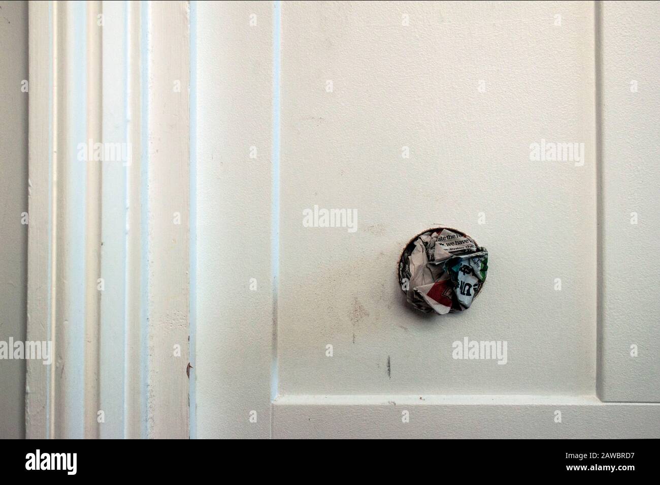 DYI project - a hole in a door filled with papers waiting to be fixed ...