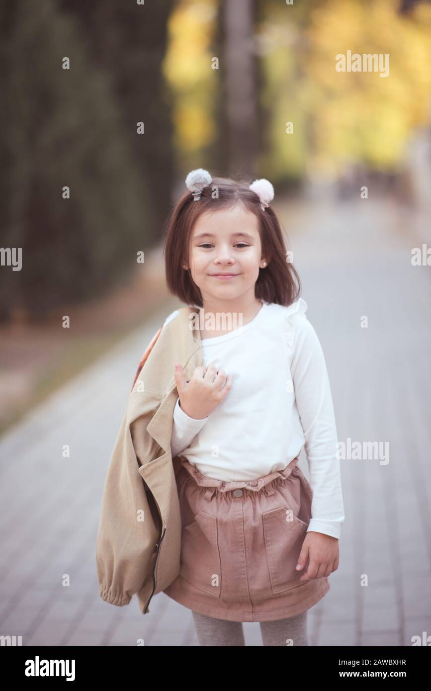 Smiling kid girl 3-4 year old wearing stylish clothes holding jacket ...