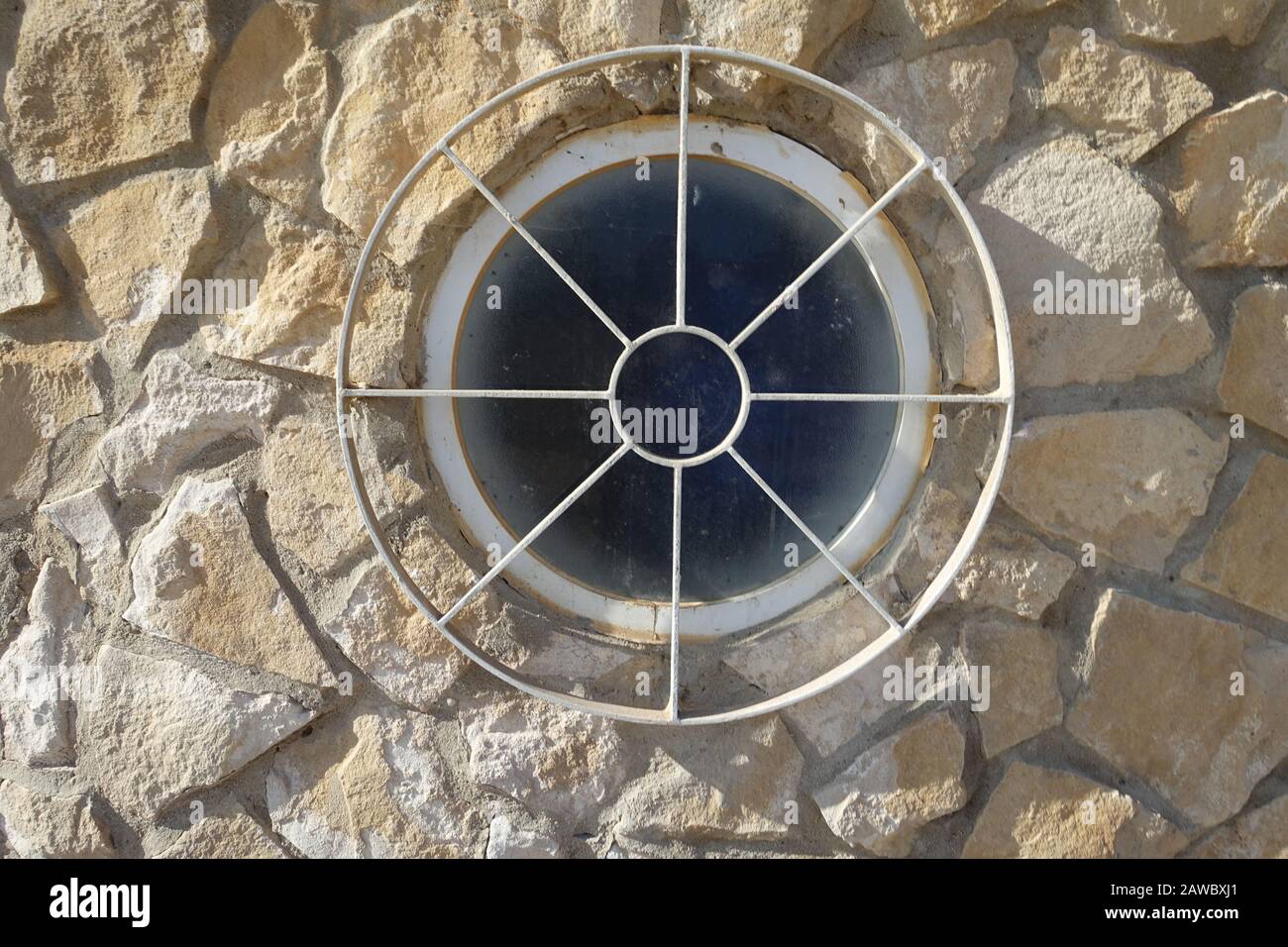 Round window with a circular metal grill Stock Photo - Alamy