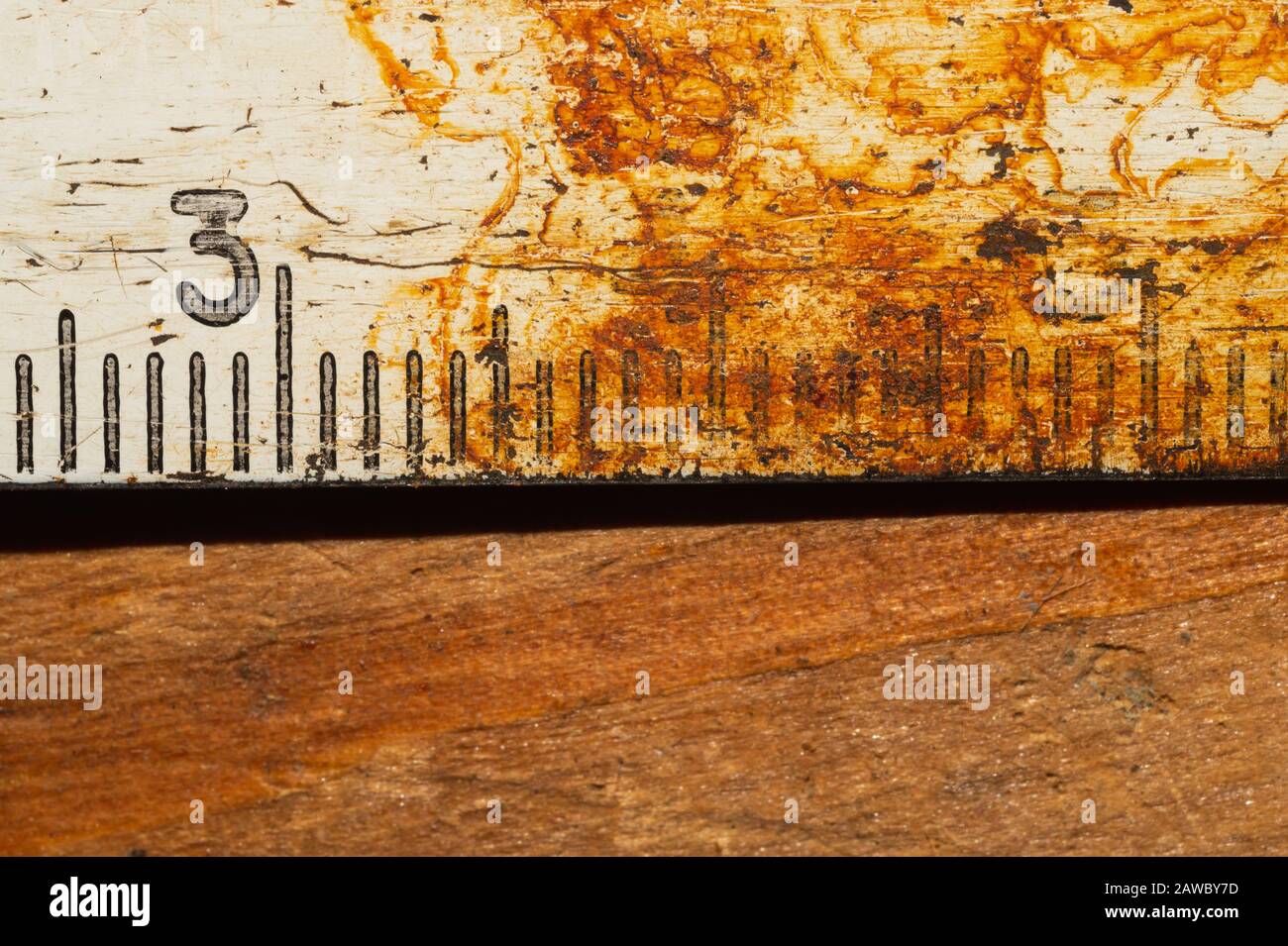 Old rusty ruler with black numbers on a working wooden table. vintage ...