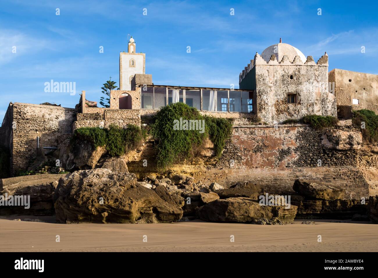 Small mosque with a traditional tower, built on a rock above the ...