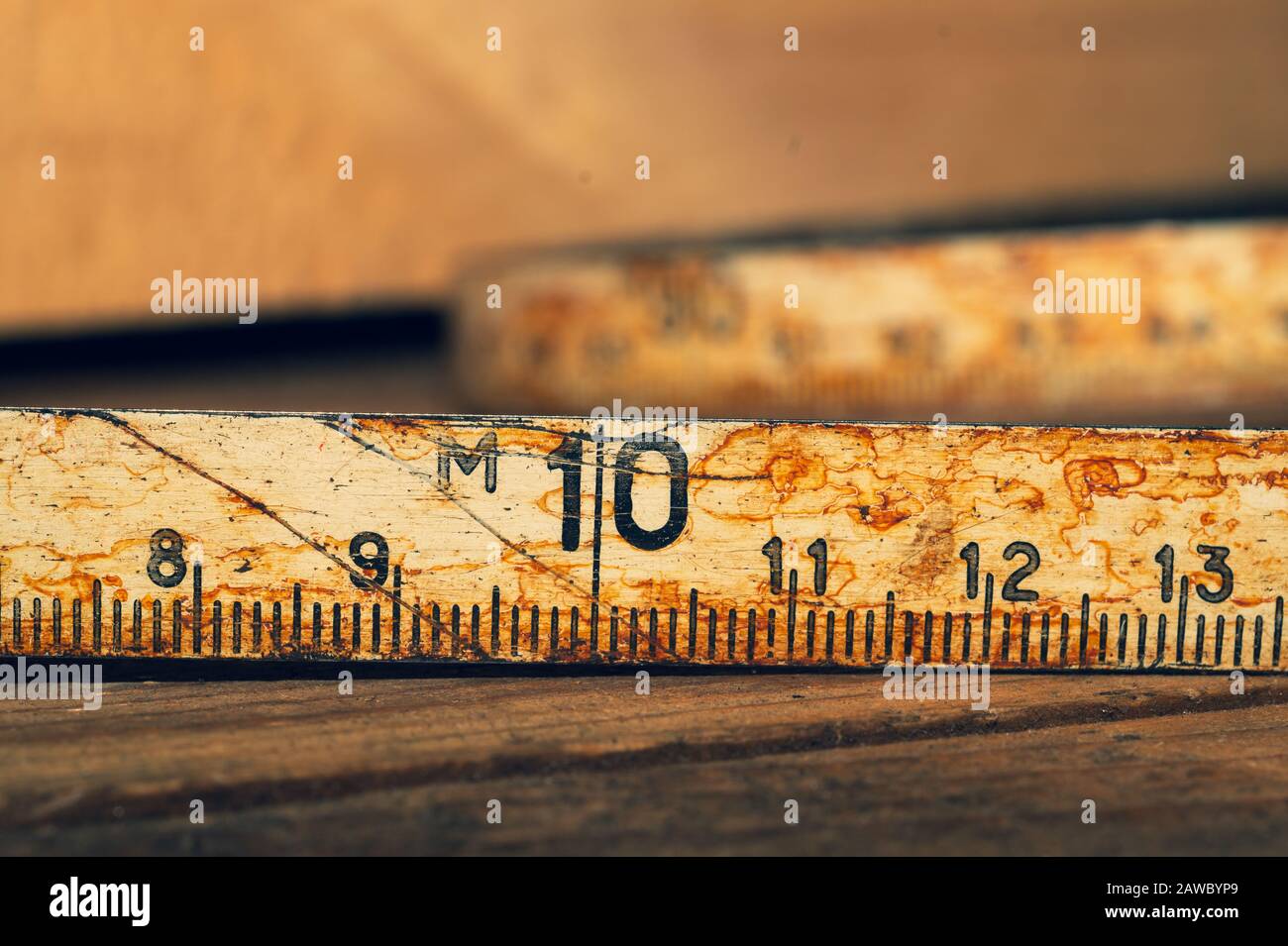 Old rusty ruler with black numbers on a working wooden table. vintage ...