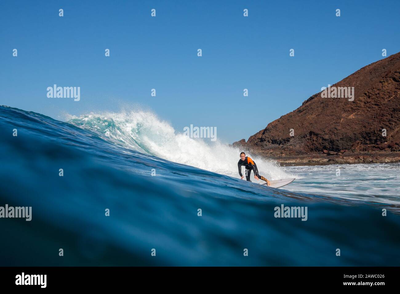 Surfer riding waves on the island of fuerteventura Stock Photo - Alamy