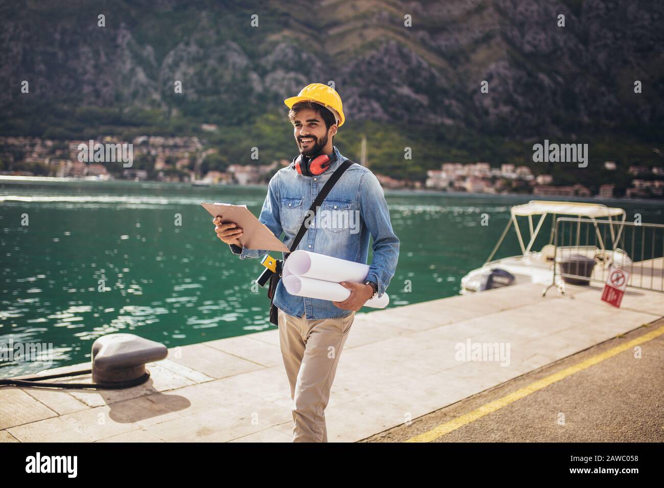 Harbor engineer holding the paper, construction work, smiling Stock ...