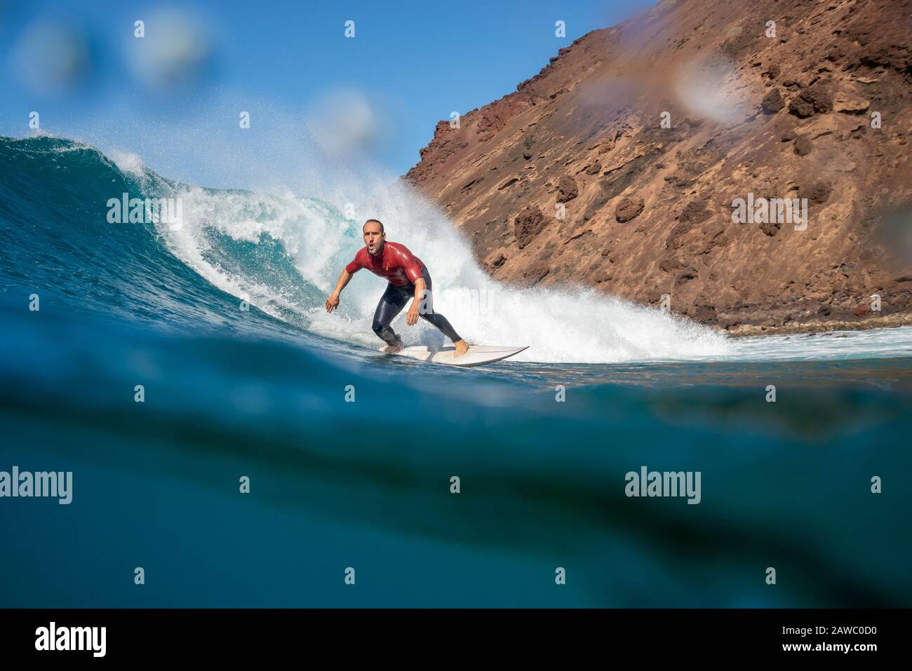 Surfer riding waves on the island of fuerteventura Stock Photo - Alamy