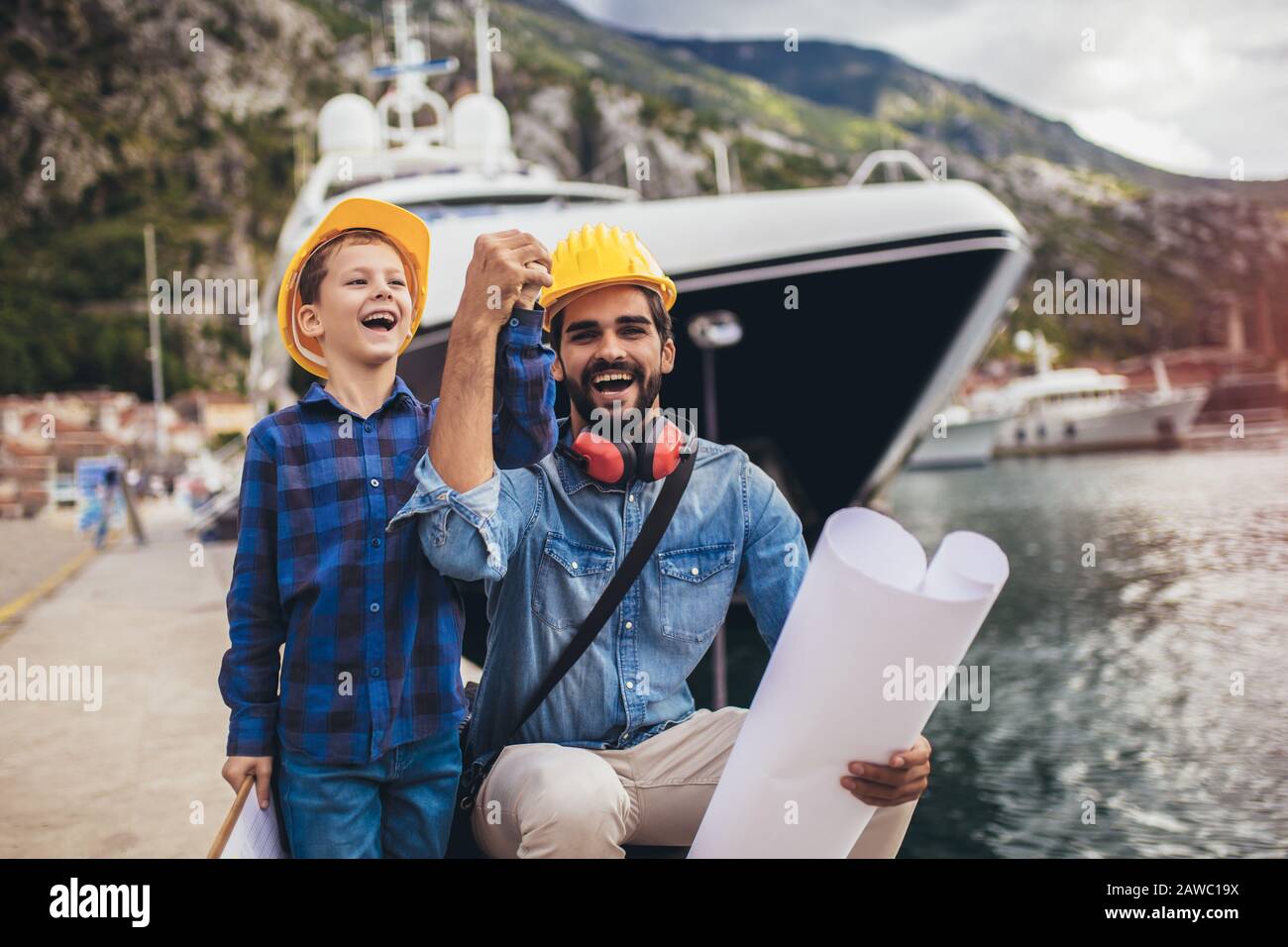 Harbor engineer with his son holding the paper, construction work ...