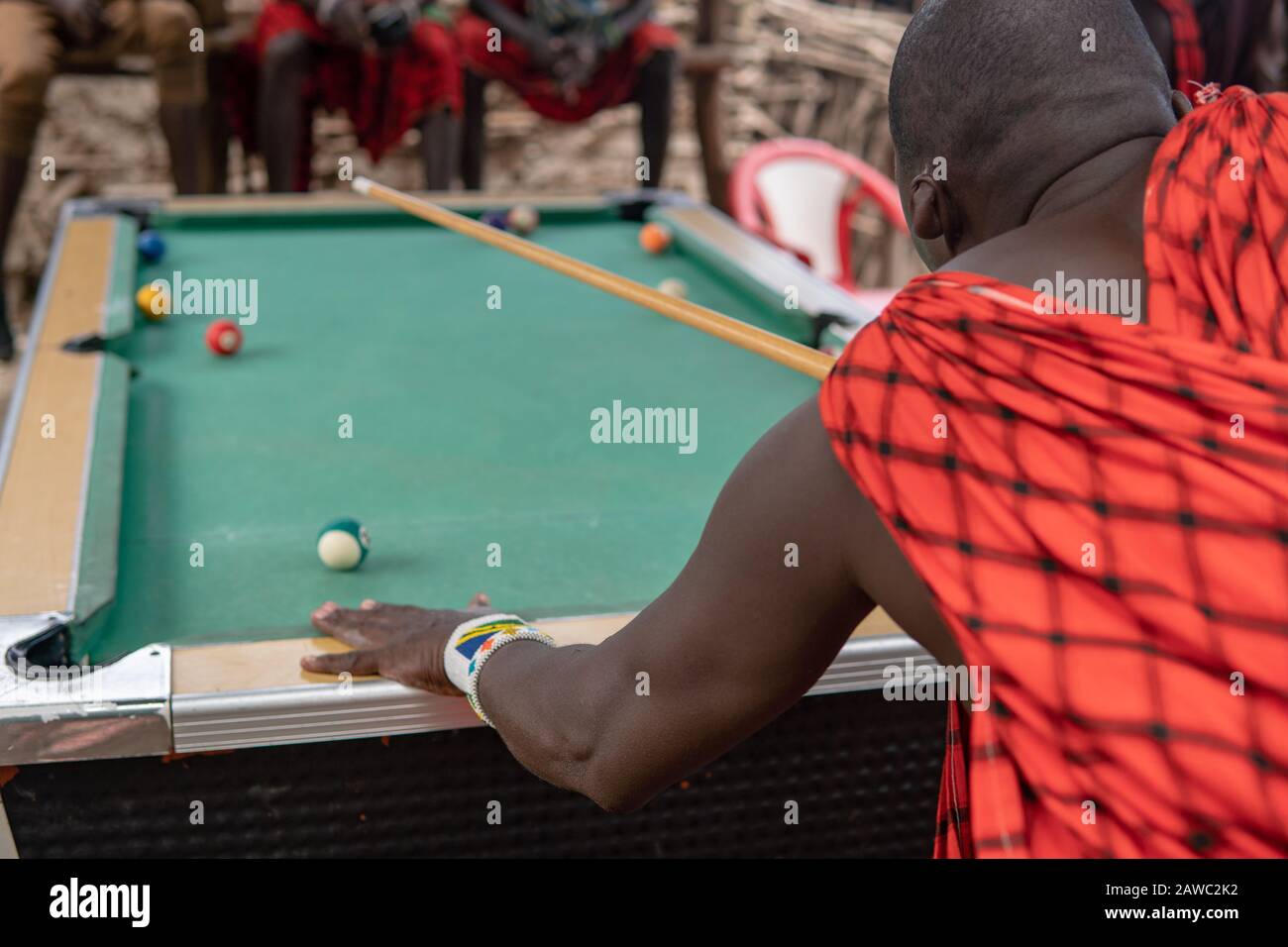 African masai men playing open air billiard pool in the village Sengare ...