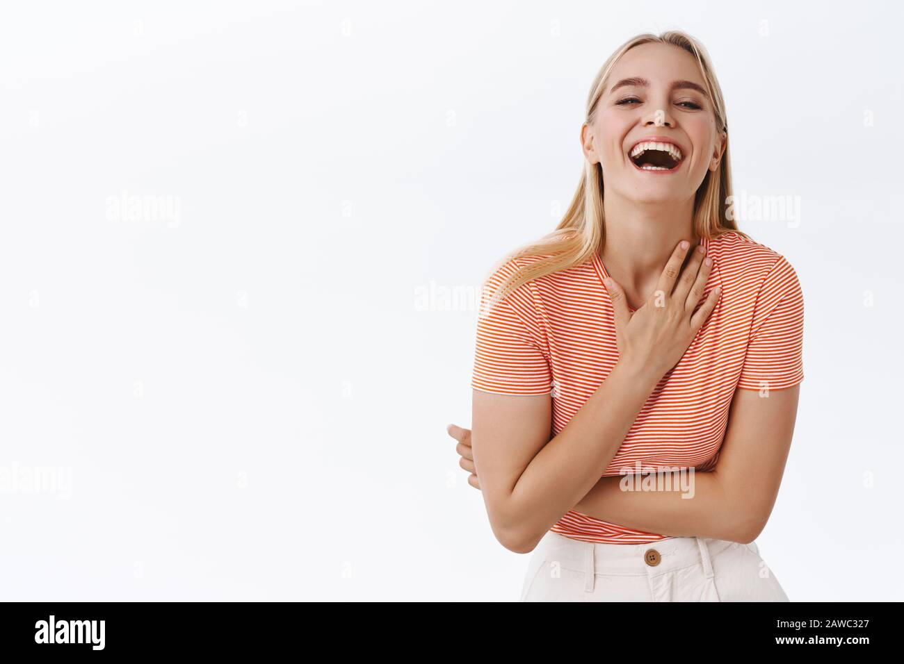 Happy and carefree, emotive blond alluring woman having fun, laughing ...