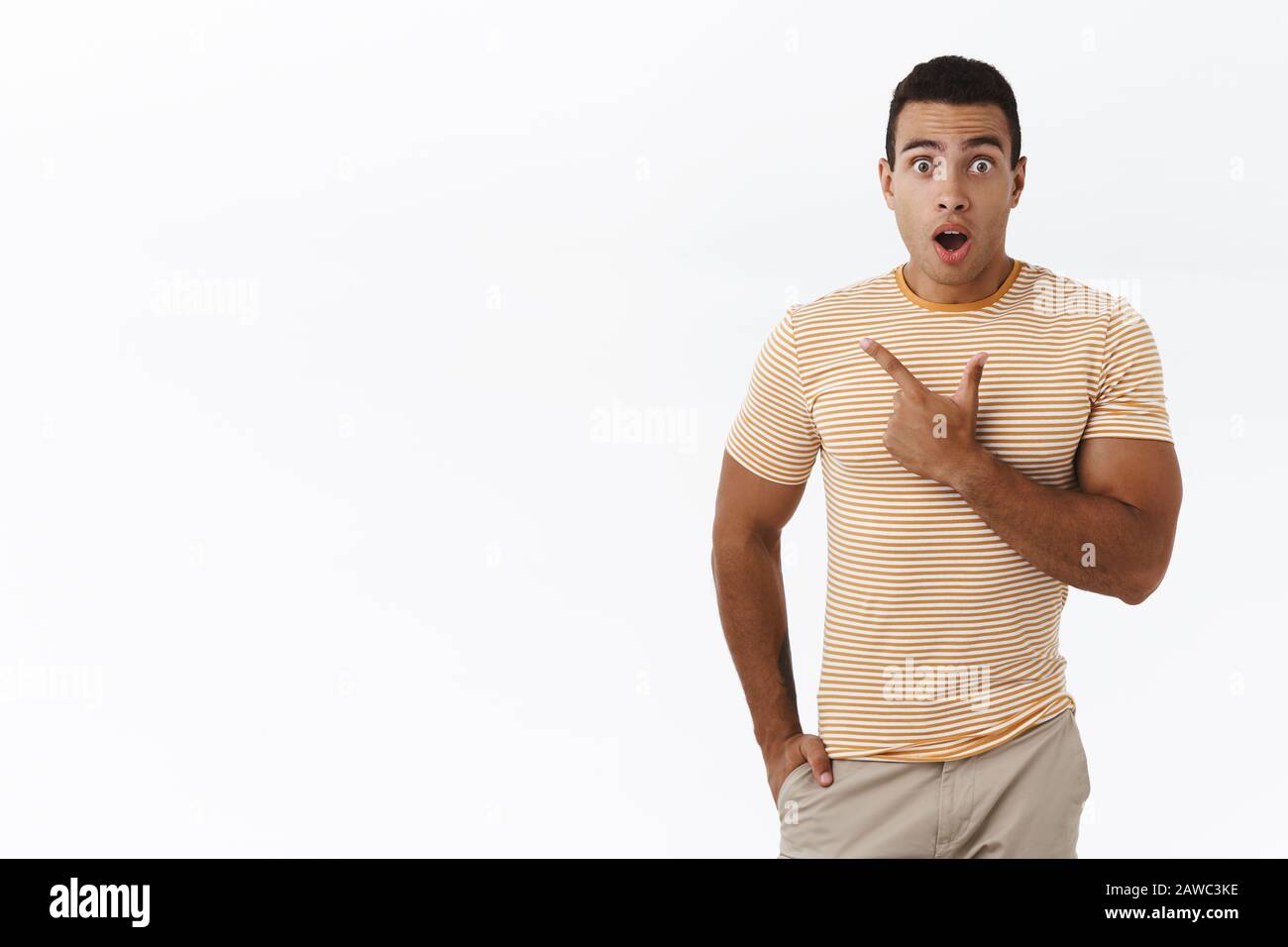 Amazed, impressed good-looking hispanic guy open mouth from surprise ...