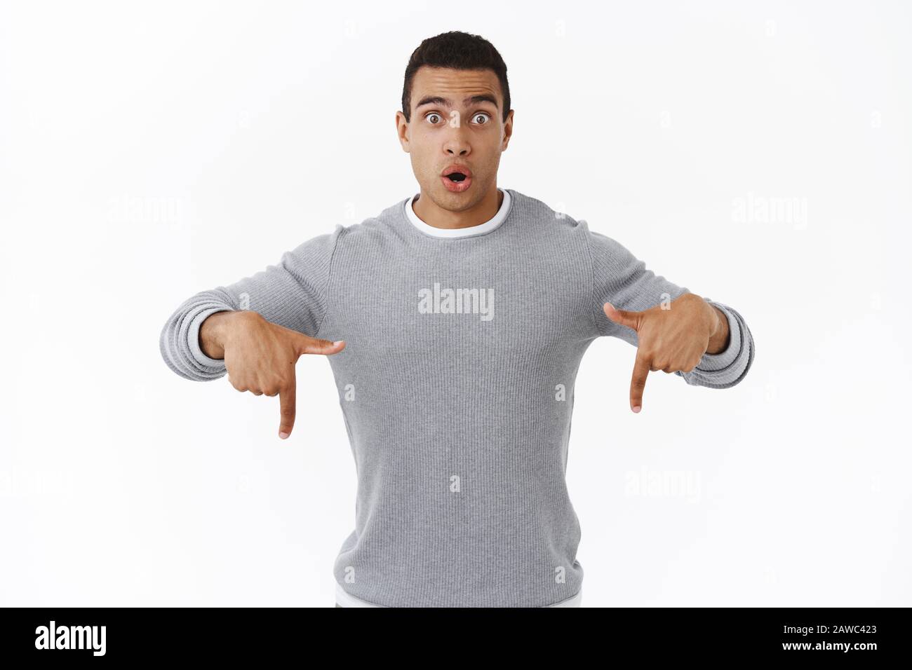 Wow look here, must have. Surprised and curious handsome young man in ...