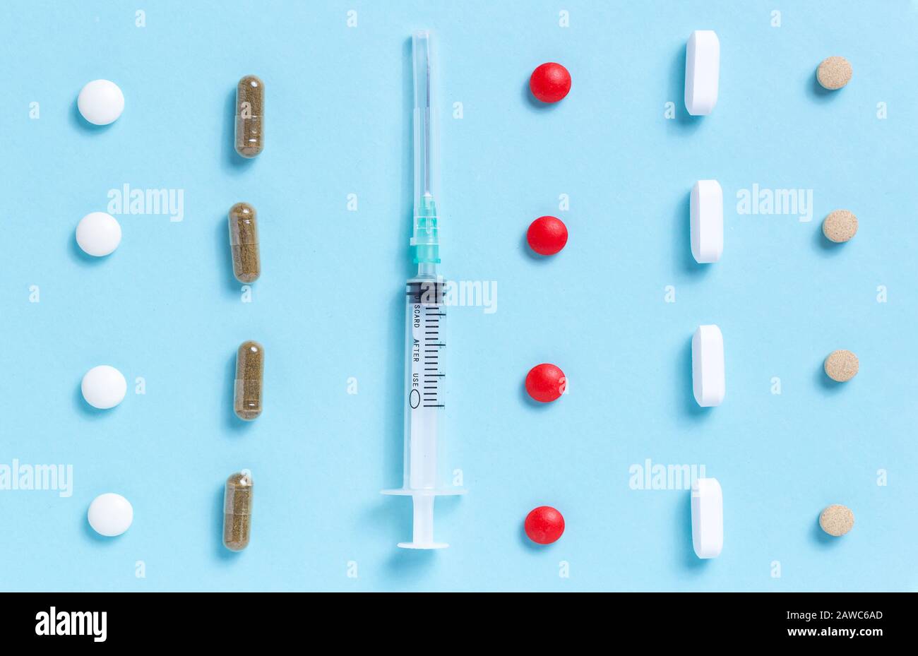 Medical syringe with rows of different colored pills Stock Photo - Alamy
