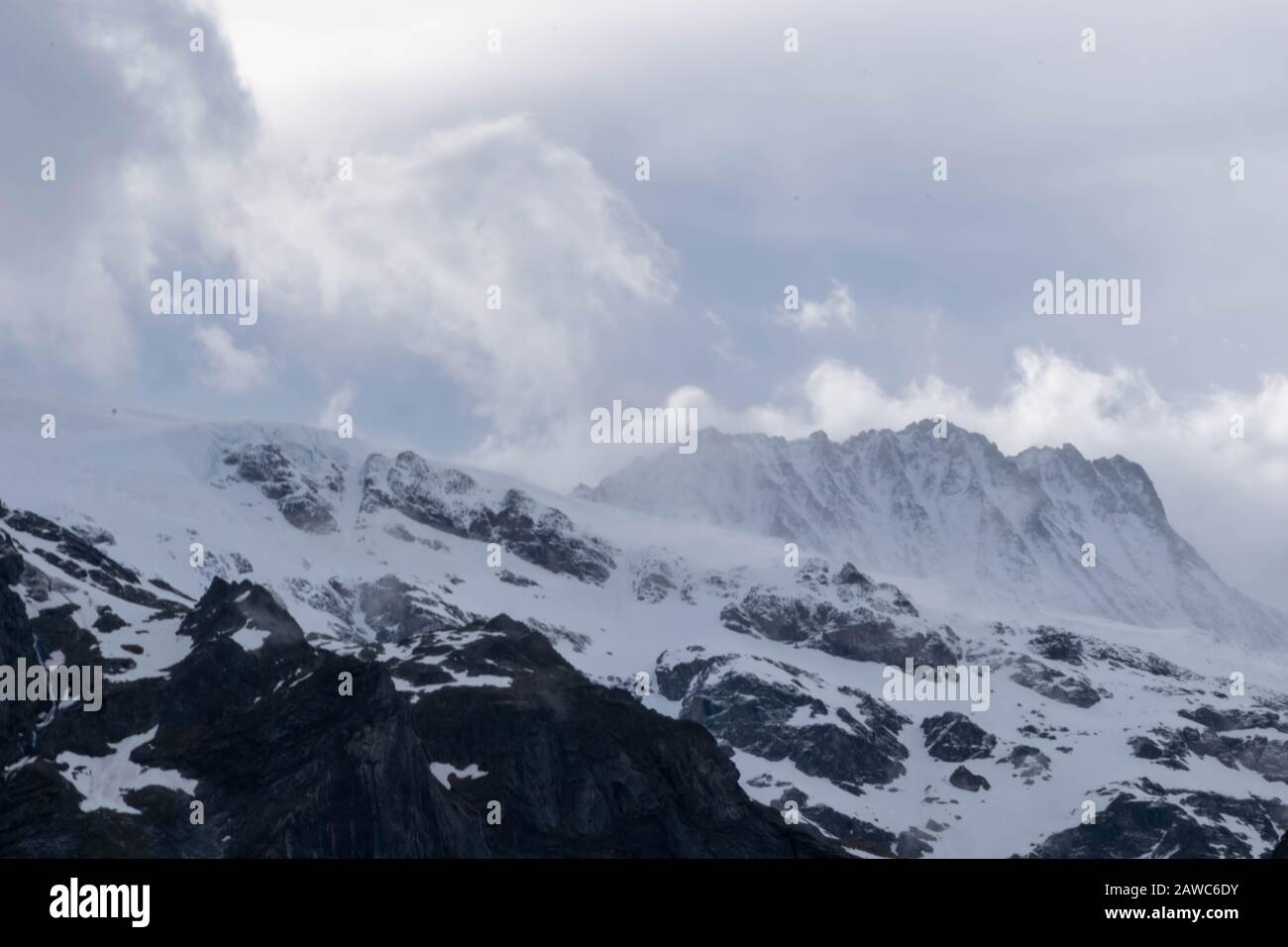 Cloudy Snowy Alps Peaks in Switzerland Stock Photo - Alamy