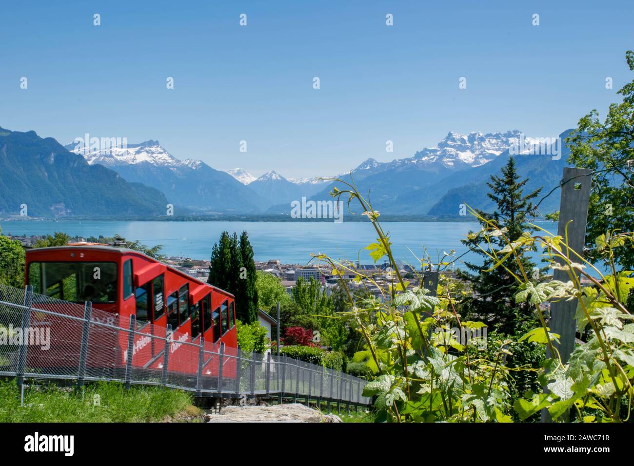 Red cable car on the top of mountain with the view on Lake Geneva and ...