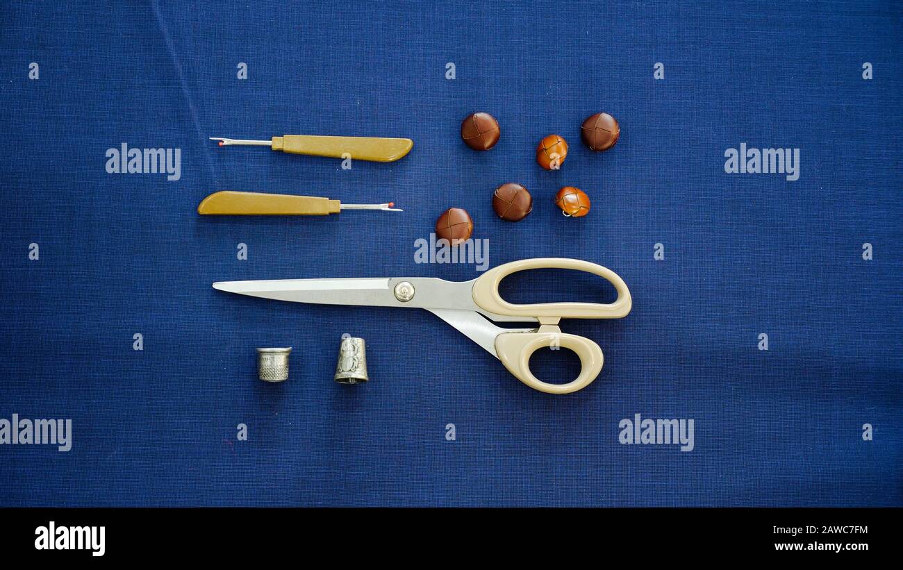 Colored fabric, scissors, centimeter, curl, buttons threads are visible ...