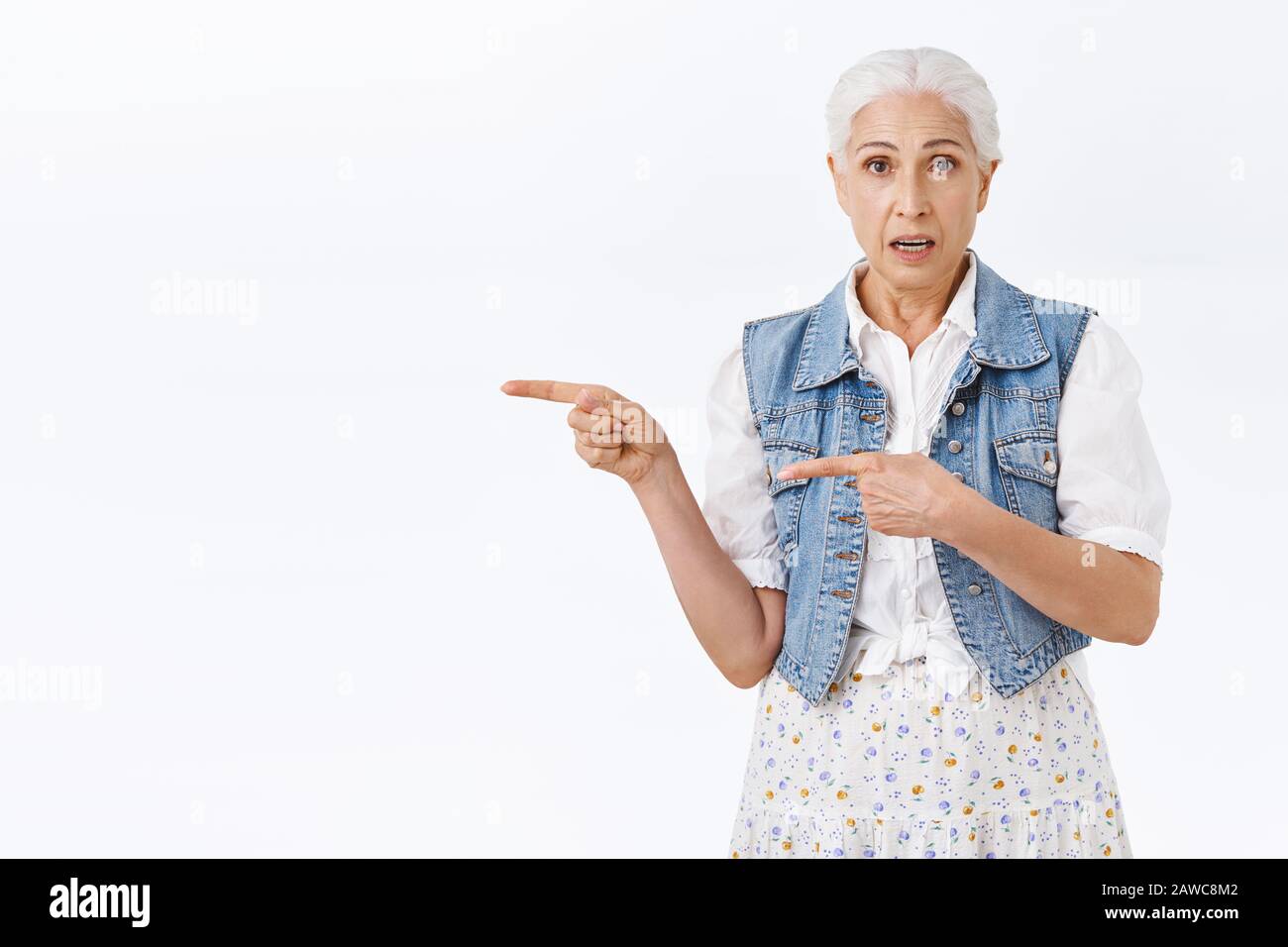 Doubtful, skeptical, indecisive senior woman, grey hair, wear denim ...