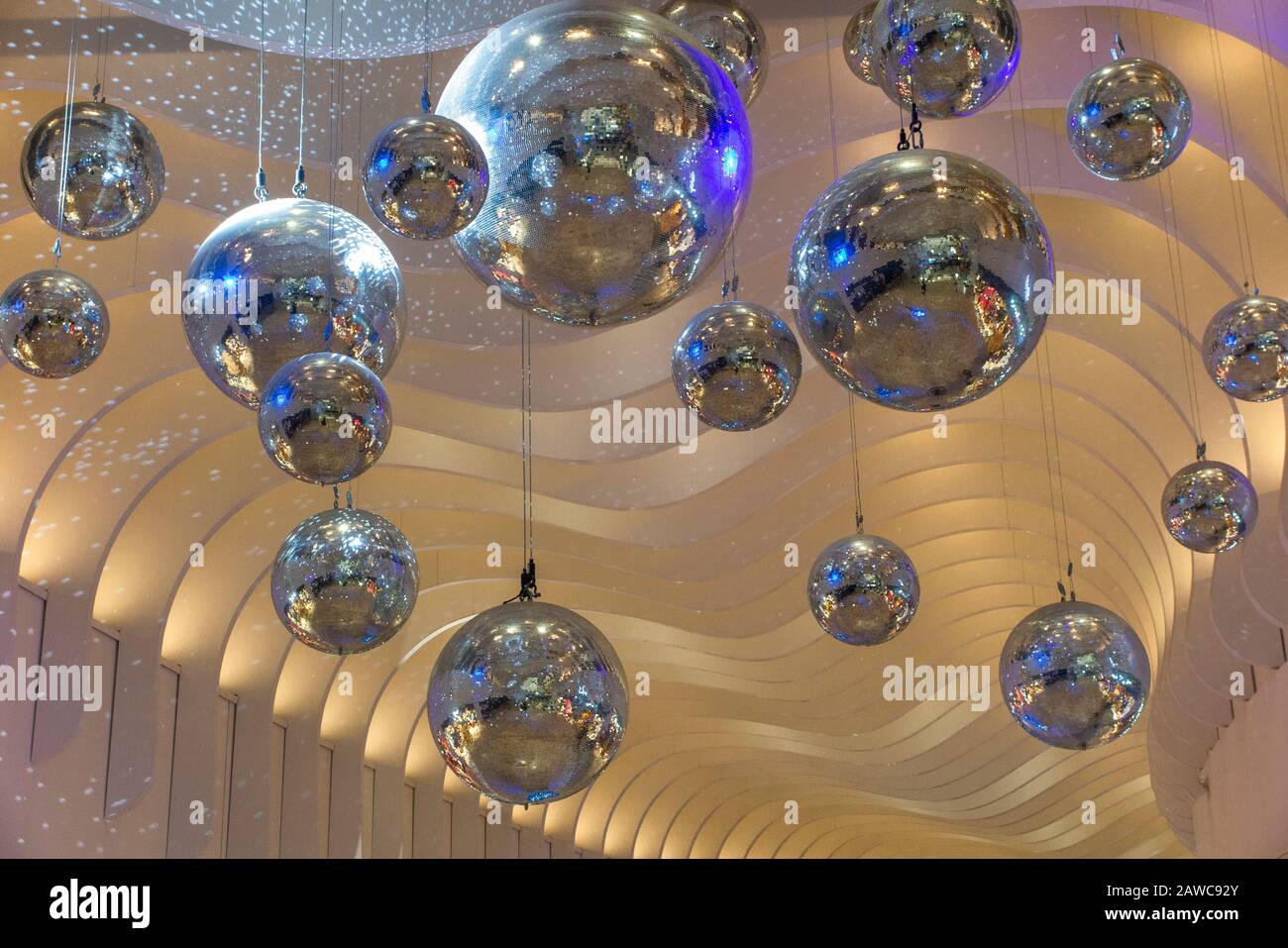 Large silver balls hang from the ceiling of the walkways of the ...