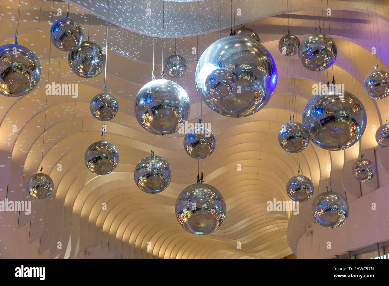 Large silver balls hang from the ceiling of the walkways of the ...