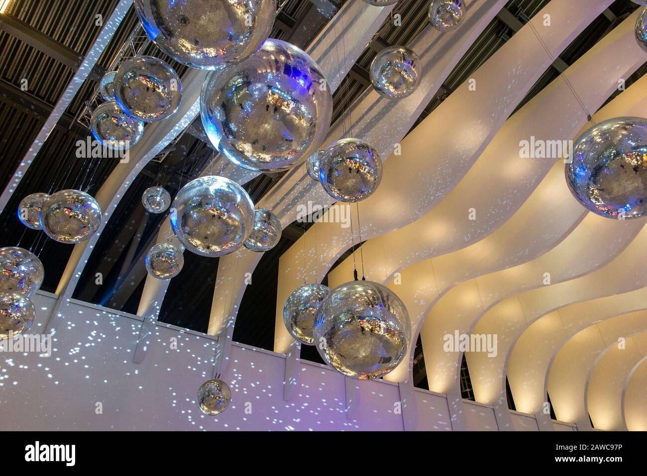 Large silver balls hang from the ceiling of the walkways of the ...