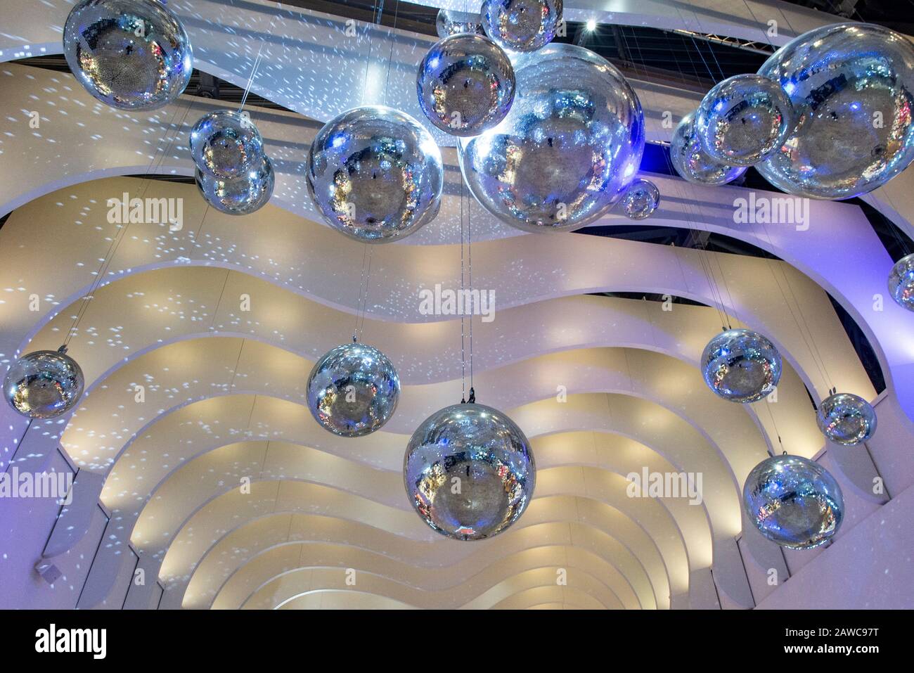 Large silver balls hang from the ceiling of the walkways of the ...