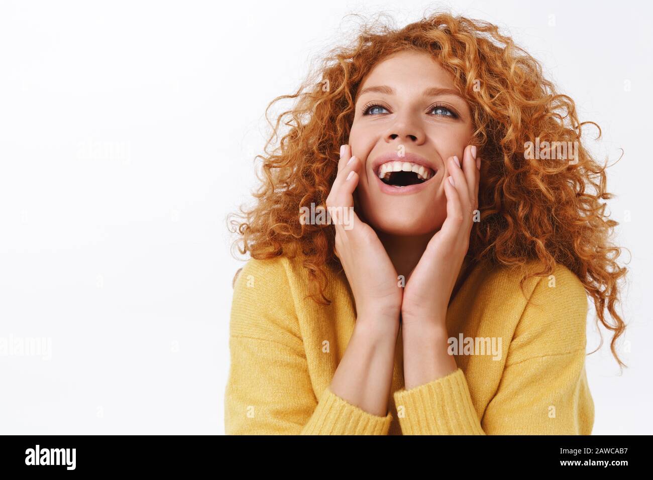 Dreamy Delighted Tender Curly Haired Redhead Woman In Yellow Sweater