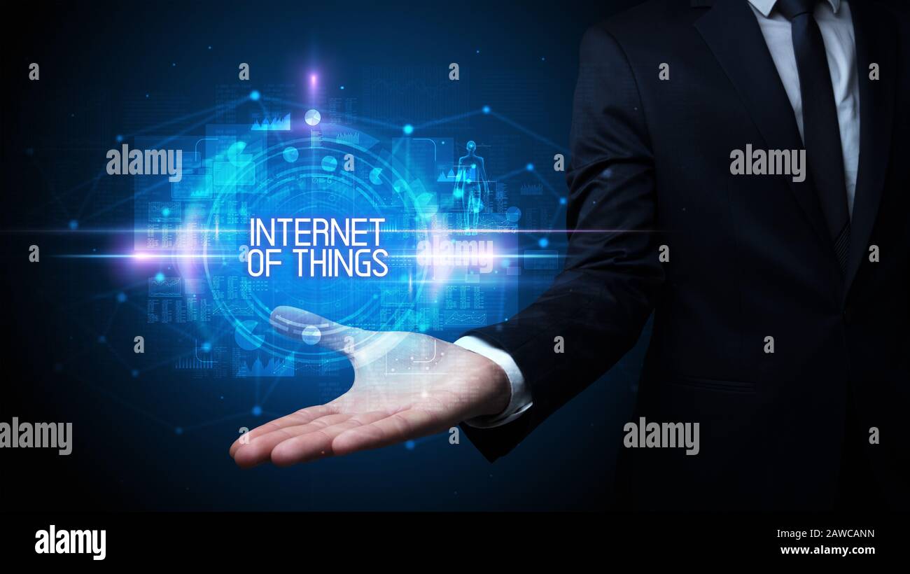 Man hand holding INTERNET OF THINGS inscription, technology concept ...