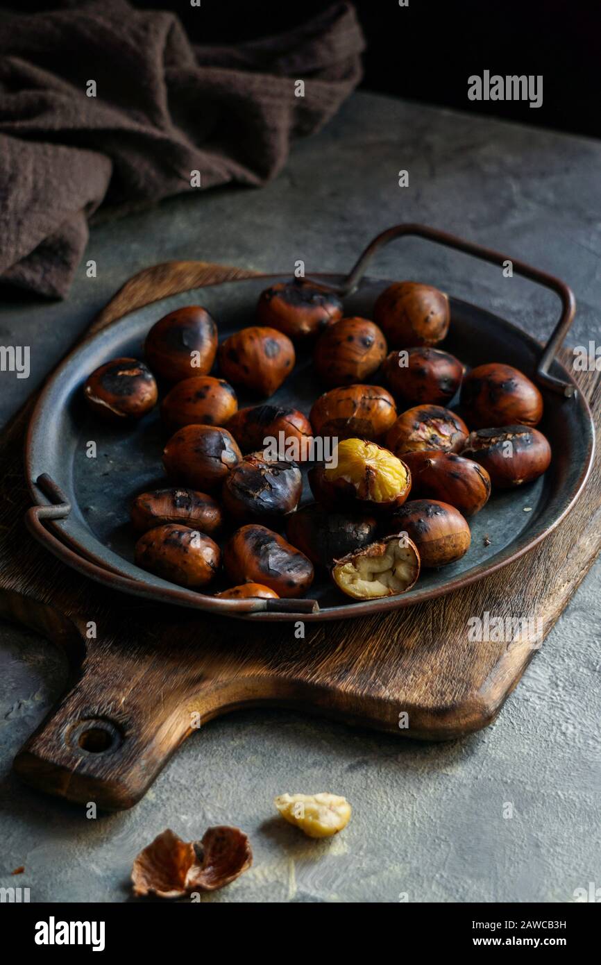 baked chestnuts, fried on the grey dark background, ready to eat, copy ...