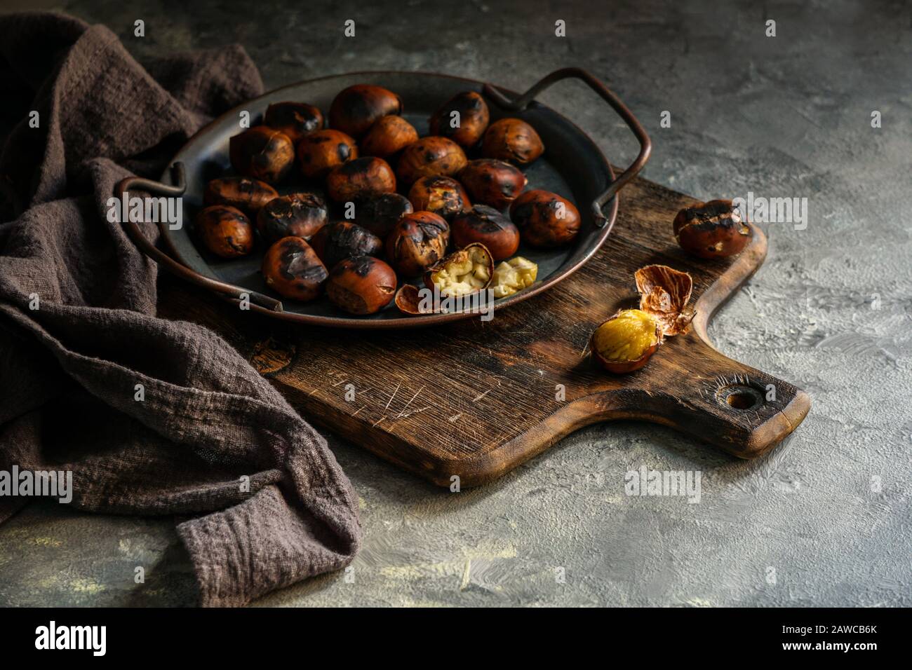 baked chestnuts, fried on the grey dark background, ready to eat, copy ...