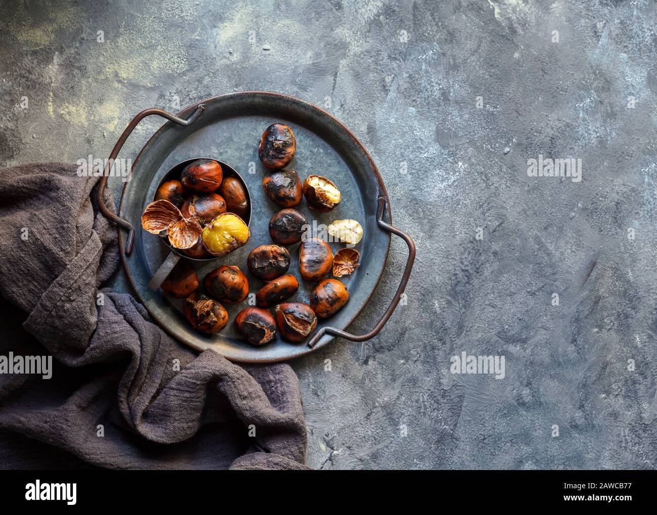 baked chestnuts, fried on the grey dark background, ready to eat, copy ...