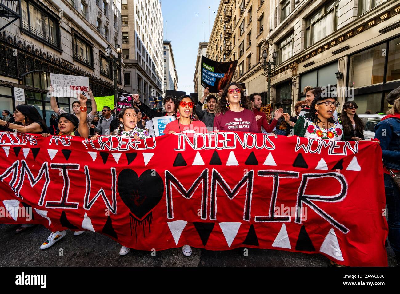 Climate change activists hold a banner and placards while shouting ...