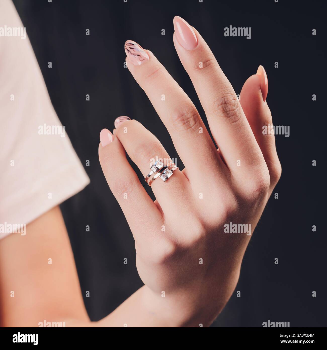 Close up of hands of woman showing the ring with diamond. She is ...