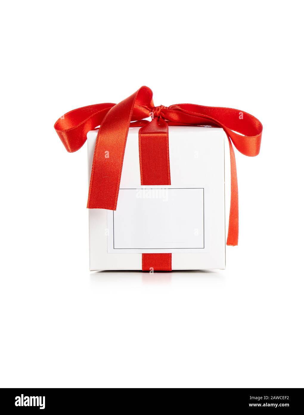 White gift box with empty lable and red satin ribbon isolated on white ...