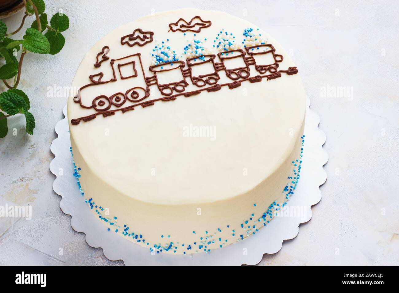 children's cake with the image of a steam locomotive on the table, a ...
