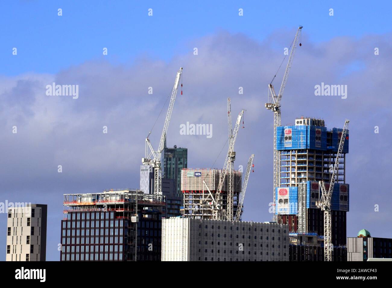 Construction of new, high rise buildings with tower cranes in central ...