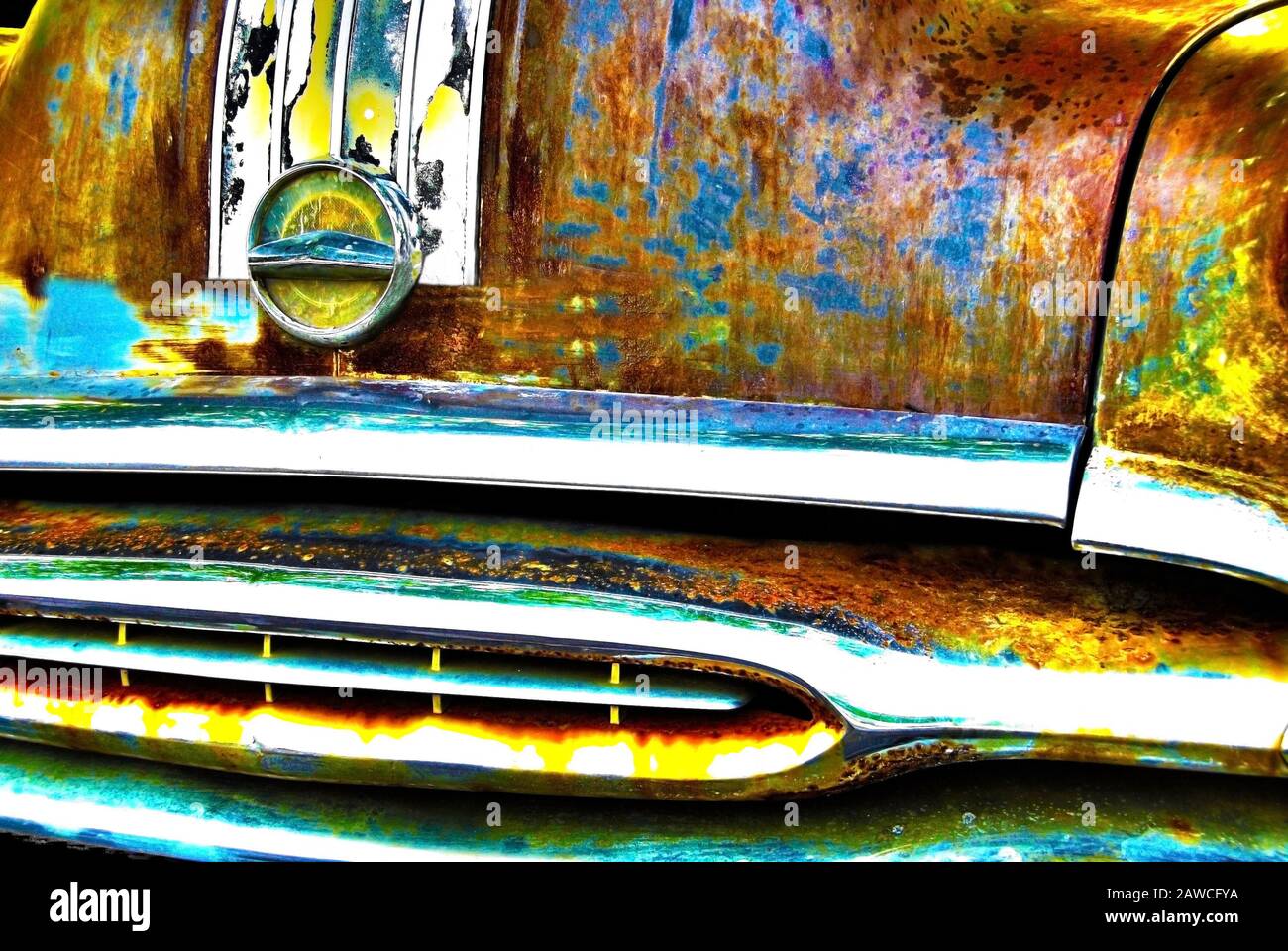 A close up abstract view of the front grill on an old scrap car in HDR ...