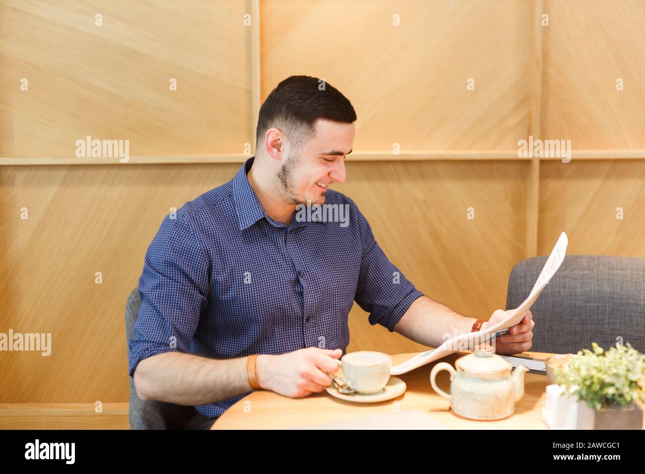 Successful businessman reading newspaper in hi-res stock photography ...