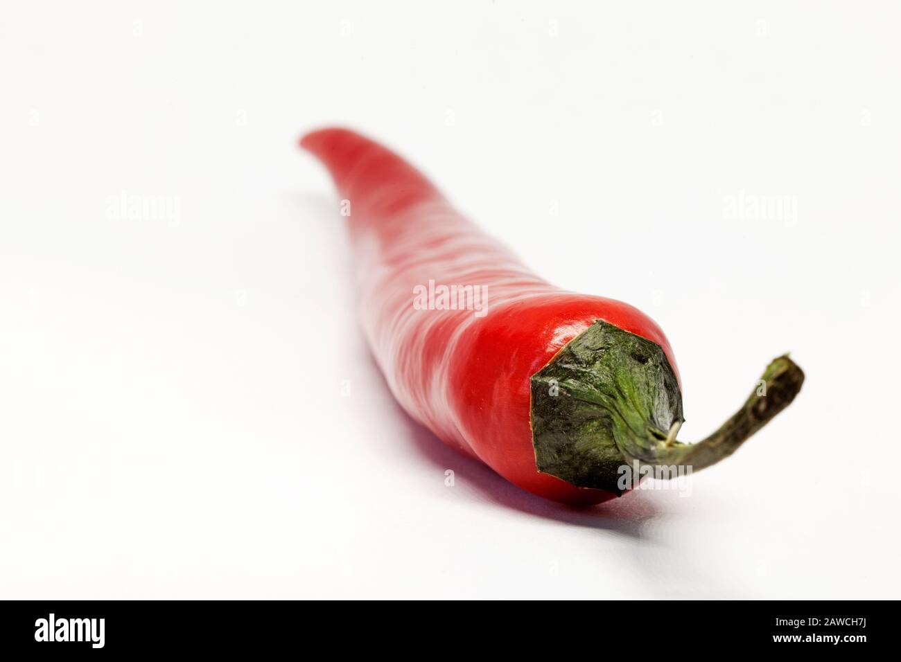 a red chili fruit on white background with green stalk Stock Photo - Alamy