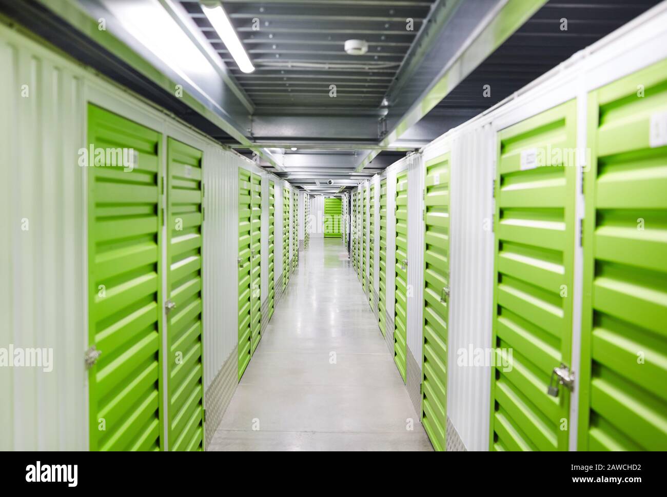 Image of green storage boxes for load in empty warehouse Stock Photo ...